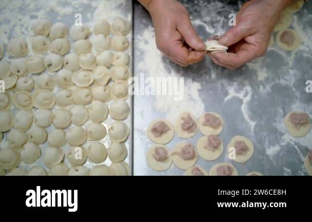 semi-finished products. cooking. close-up. cooks hands lay out pieces ...