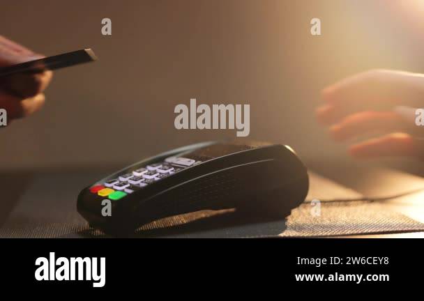 Close up hands of man making payment with credit card machine terminal ...