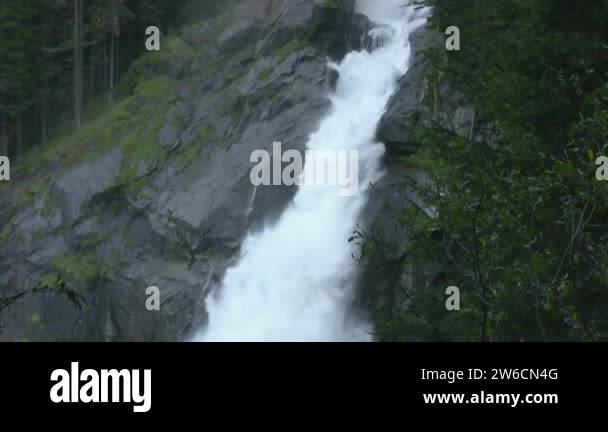 Mountain waterfall. A fast mountain river falls down a cliff. The ...