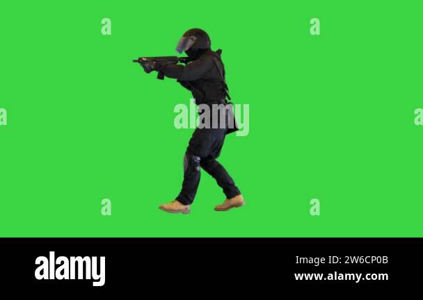 Masked Armed SWAT Police Officer Walking and aiming with rifle on a ...