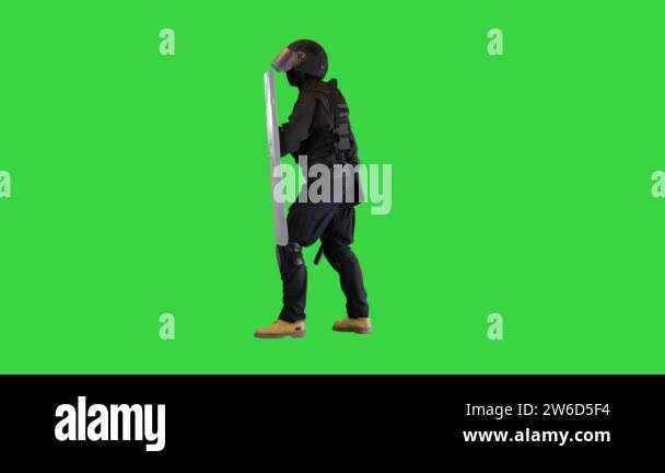 Riot police unit making sound hitting shield with baton on a Green ...