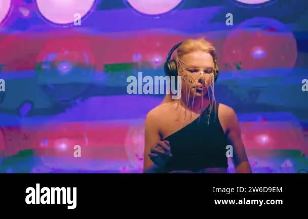 A cool and stylish female DJ of European appearance with blonde hair ...