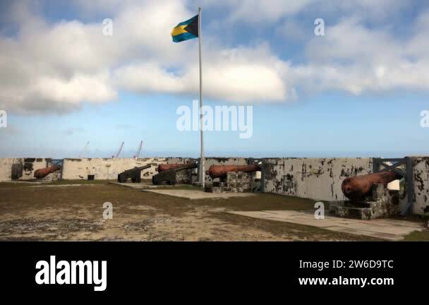 Handheld shot of the row of cannons facing the sea from Fort Charlotte ...