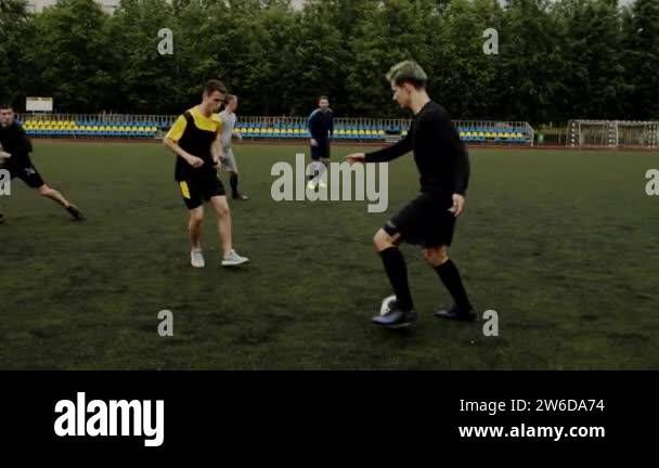 Soccer player attacks, makes a dribble feint and gives a ground pass to ...