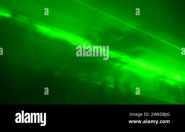 Bright beams of green neon laser light flashes and emitting lights in a ...