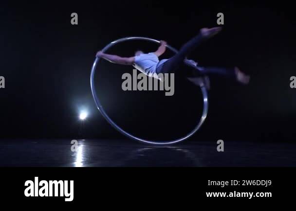 Circus artist shows concentration and balance while spinning on a Cyr ...
