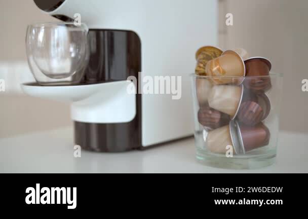 Modern coffee capsule machine on the table in the office with copy ...