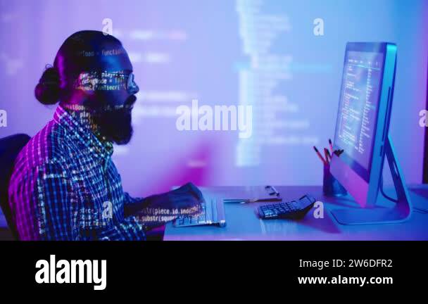 Lockdown Of Young Indian Programmer With Beard Sitting At Computer And Typing Code Of New
