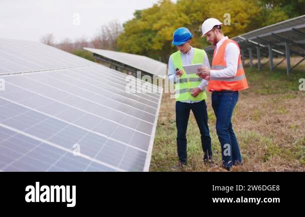 Two ecological engineers at the solar panels park controlling the ...