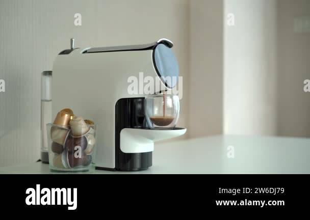 Modern coffee capsule machine on the table in the office with copy ...