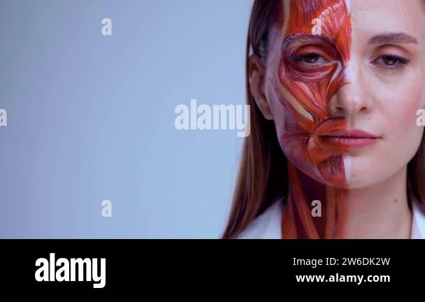 Young woman with half of face with muscles structure under skin. Model ...