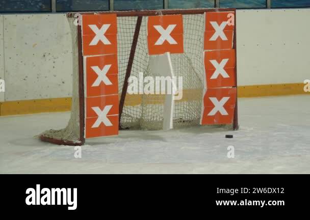 Hockey Puck Flying into Gates Net in Slow Motion with Spotlight Flares ...