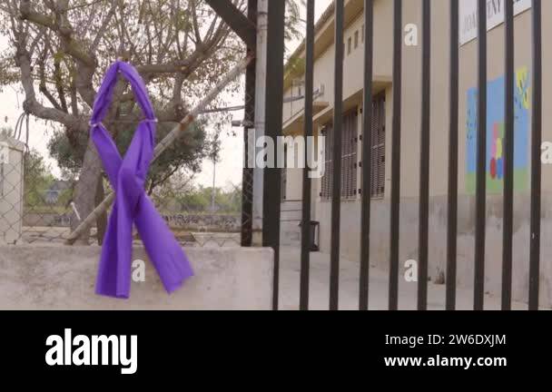 Symbol of a purple ribbon made of fabric and tied with flanges to a ...