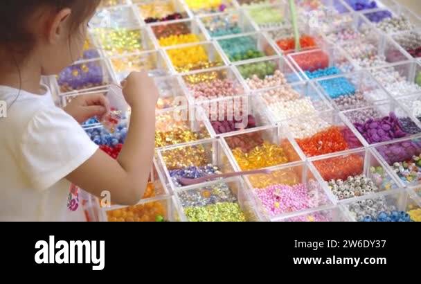 Children sculpt and play with glitter textured slime, stretching the ...