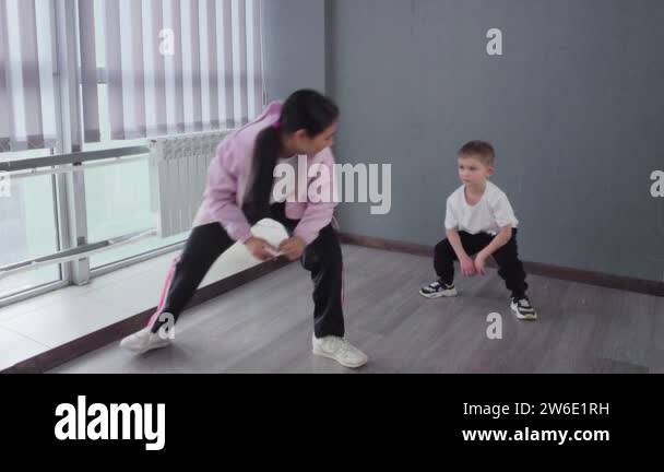 Little boy do exercise to warm up to get ready for breakdance hip-hop ...