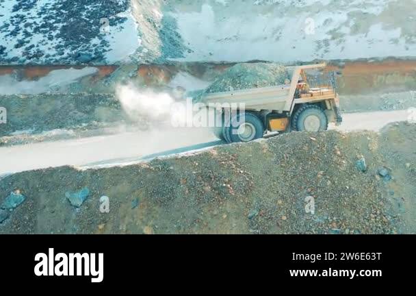 Mining industry concept. Side view of a loaded truck riding along the ...