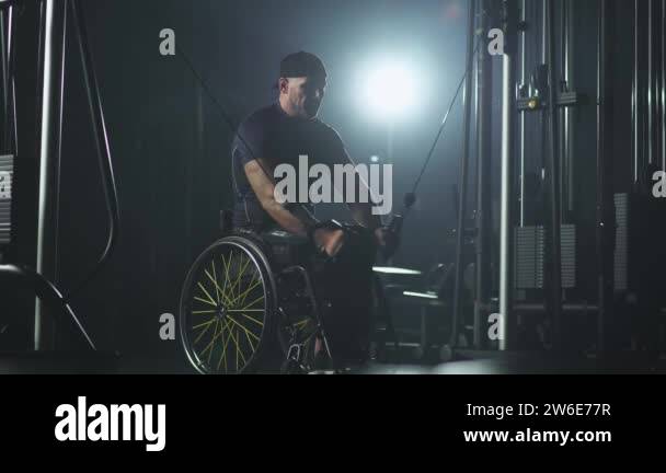 Fortitude, disabled athlete in wheelchair lifting blocks on rack ...