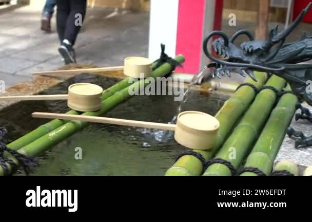 Purification by washing hand at the fountain of sanctuary in Kyoto ...
