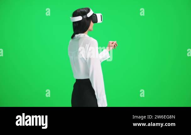 Female in futuristic virtual reality glasses controls the virtual ...