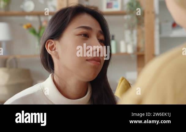 Sad young asian woman hug cuddle embracing with best friend in living ...