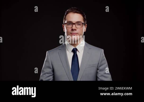 Studio portrait of successful and smart businessman in suit and tie ...