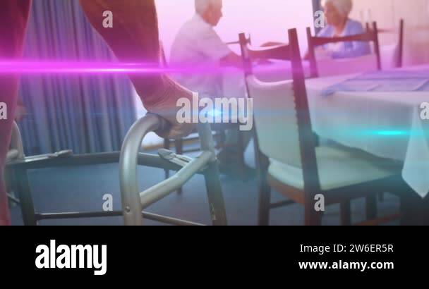 Animation of coloured lights moving over senior man in dining room ...