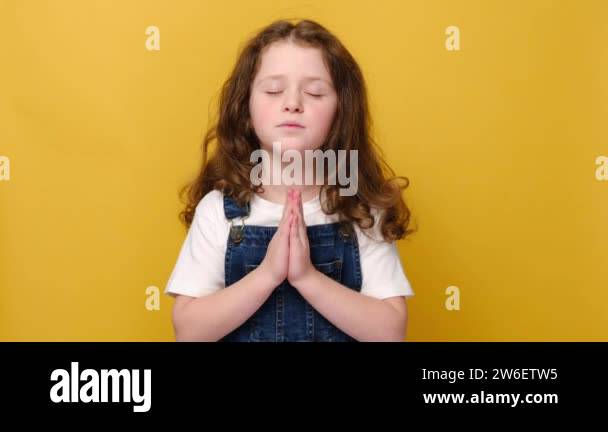 Hopeful cute little girl kid keep hands in prayer hope believe ask good ...