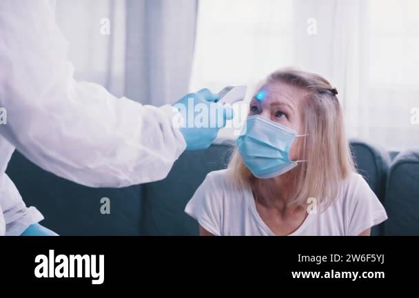 Body temperature measurement. Laser contactless thermometer. Doctor ...