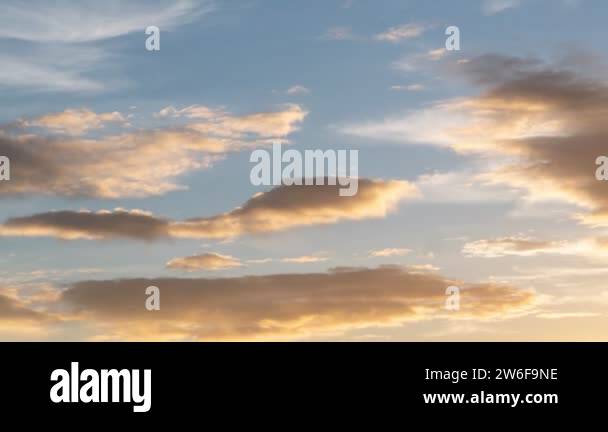 Abstract Building motions clouds sunset sky. Puffy fluffy white clouds sky time lapse. slow ...
