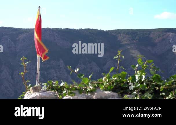 Red flag of Montenegro with golden double headed eagle placed on top of ...