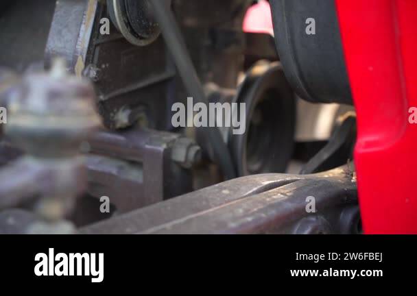 Car engine alternator and fan belt moving with rotational speed. Old ...
