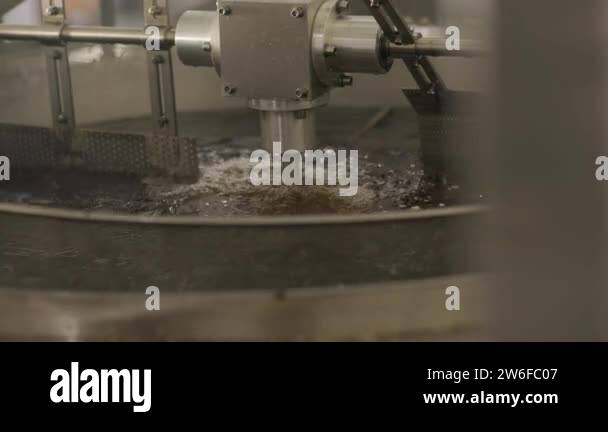 Production of potato chips and snacks. Industrial deep frying machine ...