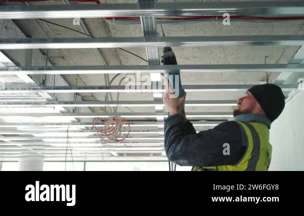 A master who drills a hole in the ceiling with a drill. Creation of ...