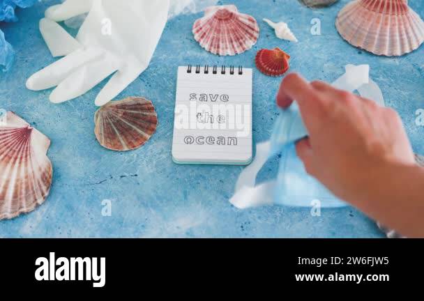save the ocean text on blue background with sea shells and plastic ...