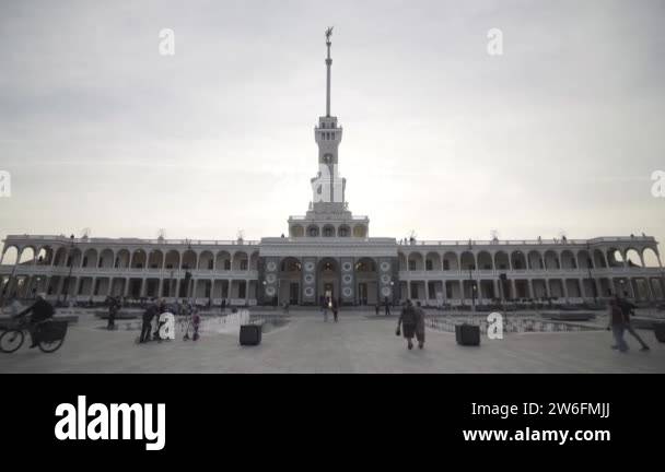 Clock tower and the city square with walking people during daylight ...