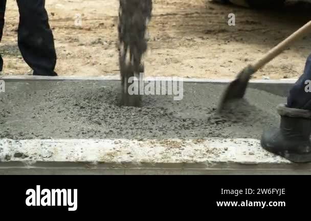 Workers are pouring concrete into the formwork of the house. Workers ...