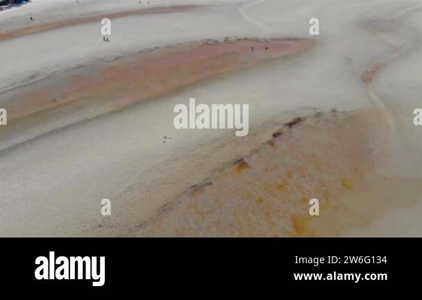 Large Colourful Puddles Form On The Beach Sand Creating A Unique Design ...