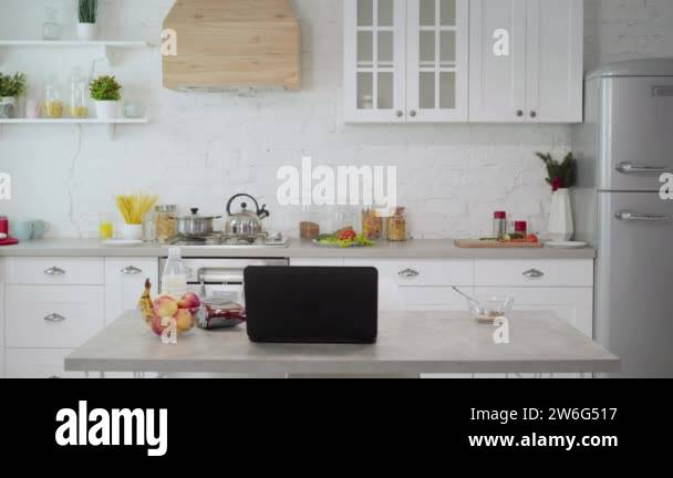 Hurrying young man running in kitchen, eating morning cereals with milk ...