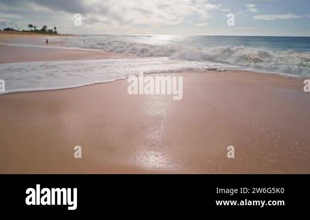 People swim in the ocean. Yellow sand at Sandy Beach on the tropical ...