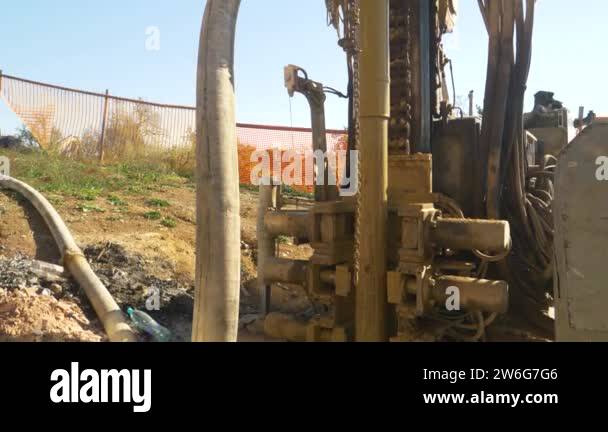 CLOSE UP: Massive hydraulic drill boring into the ground at ...