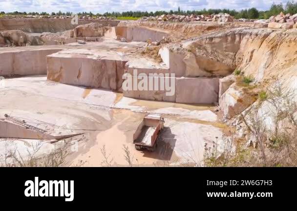 Operating quarry for the extraction of red granite in summer Stock ...