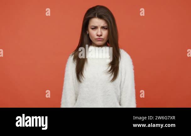 Deeply upset frustrated woman in white sweater showing and holding red ...