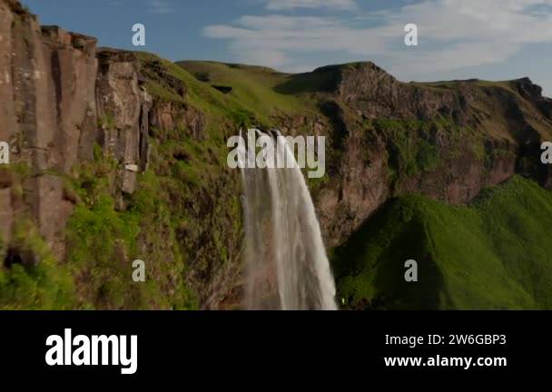 Birds eye flying over stunning Seljalandsfoss waterfall in Iceland ...