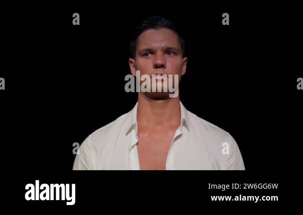 Close-up face and shoulders of young man, anxiously, fearfully, tensely ...