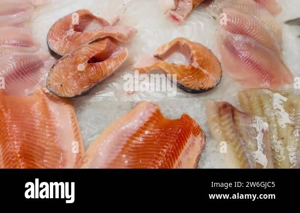 Close-up of fresh fillet of raw fish in pieces of ice. Chilled fish ...