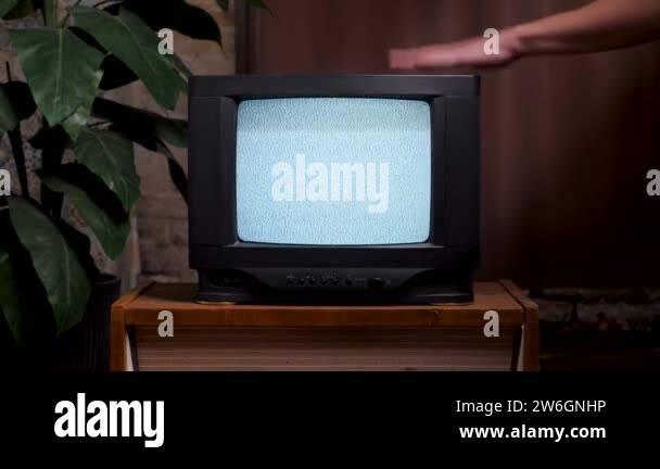 Man hitting old TV screen close up. 80s home interior old television ...