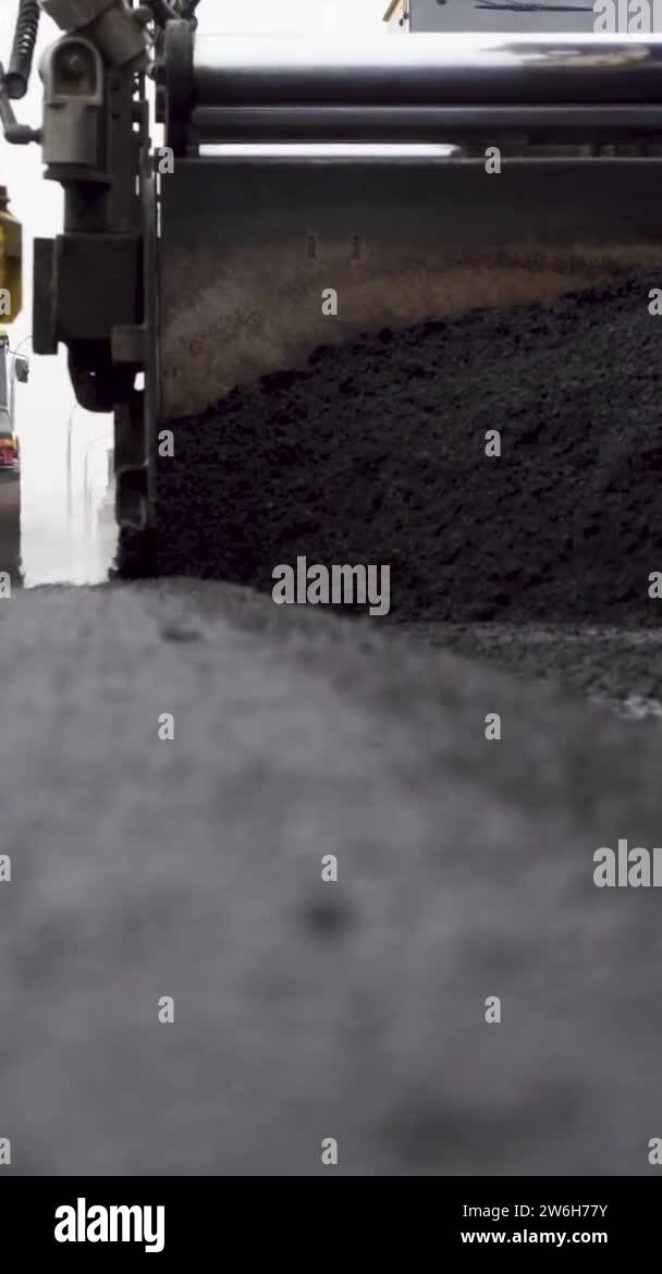 Vertical video Crawler build new road. A large and heavy equipment ...