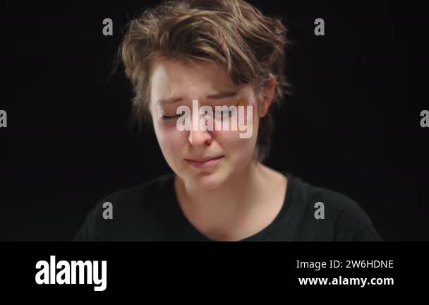 Close-up beaten face of abused crying young woman looking at camera ...