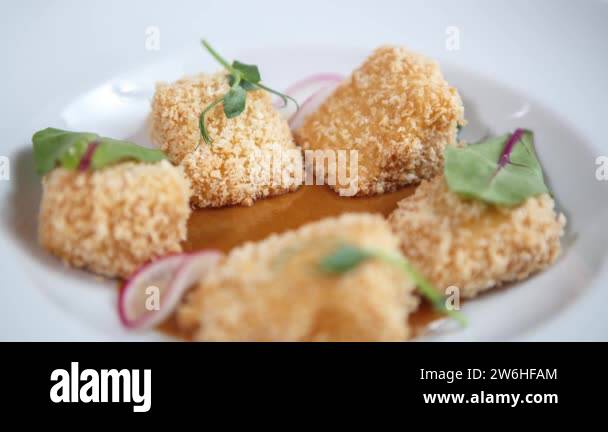 Stock food video with breaded mozzarella cheese cooked in deep fryer ...