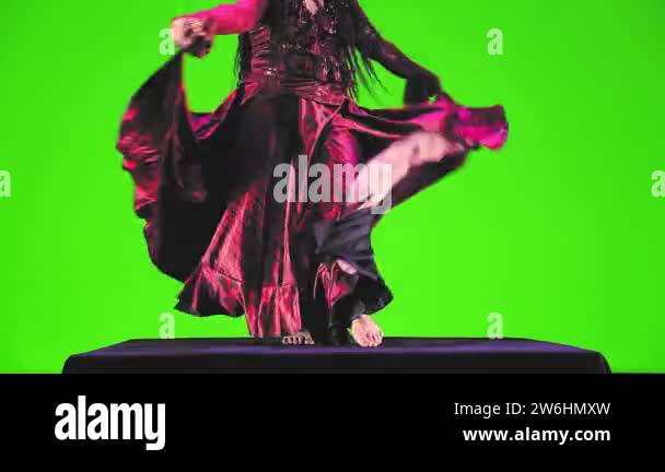 A barefoot gypsy woman without a face with long black hair in a red ...
